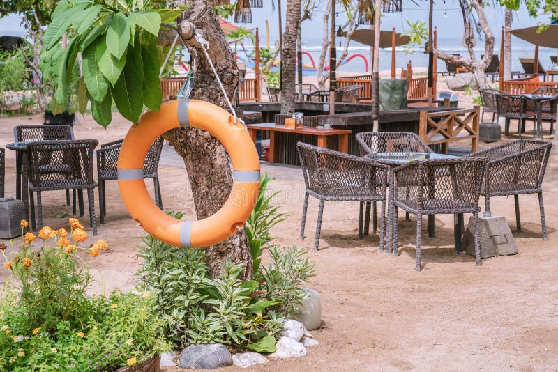 Orange Rescue Lifebuoy Hangs on Tree in Front of Beach Restaurant at ...
