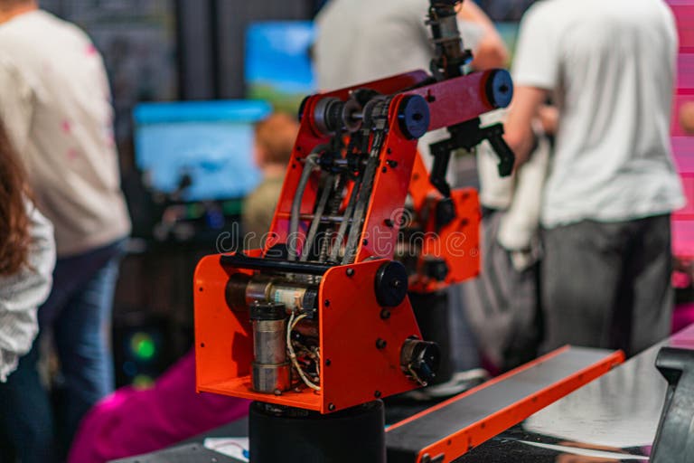 Orange Robotic Arm, Technology or Robotics Event, Bright Lighting ...