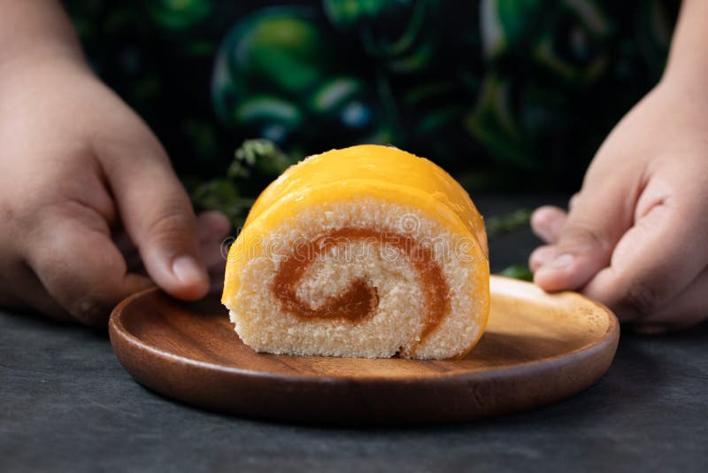 Orange Roll Cake in Wooden Plate on Black Background Stock Image ...
