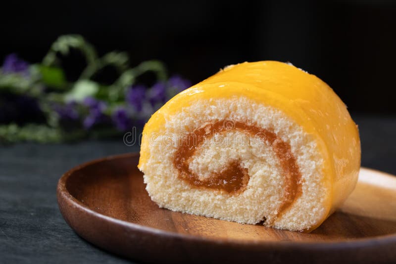 Orange Roll Cake in Wooden Plate on Black Background Stock Image ...