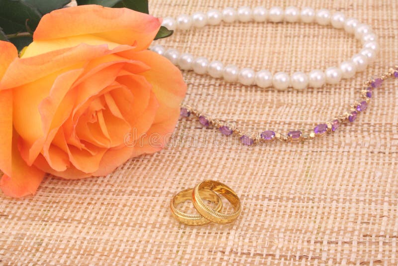 Orange Rose with Gold Wedding Rings and Pearls Stock Photo - Image of ...