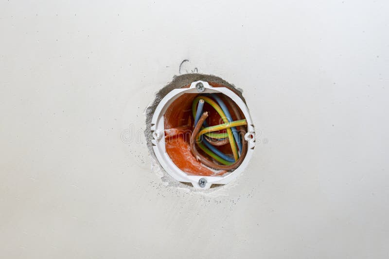 Orange, Round Junction Box Mounted in the White Wall with Protruding ...