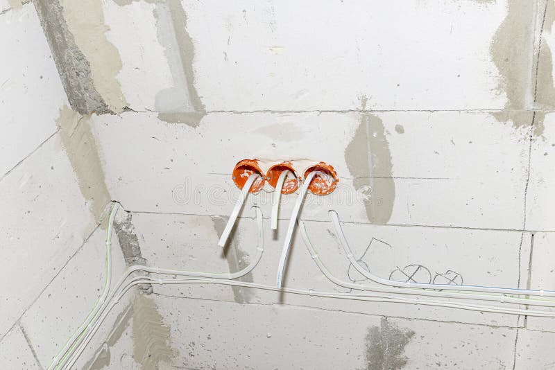 Orange, Round Junction Box Mounted in the White Wall with Protruding ...