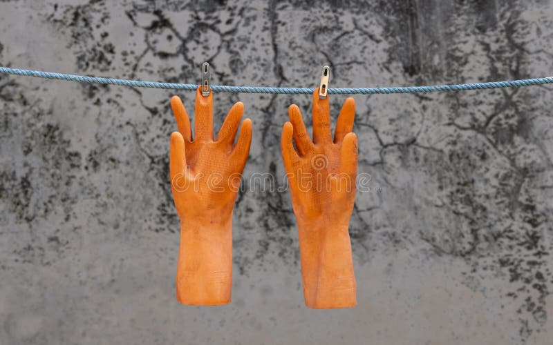 The Orange Rubber Gloves are Hanging with the Plastic String on ...