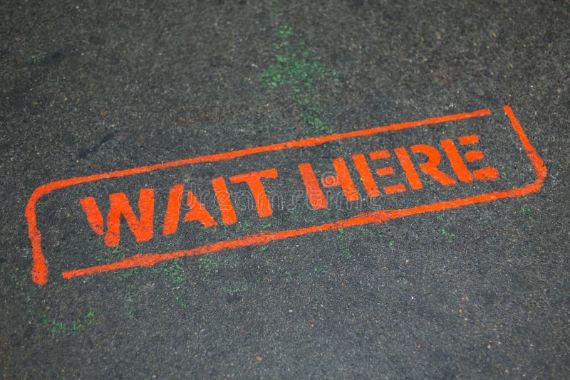 Orange Sign WAIT HERE on Asphalt, Place To Wait for Boarding the Bus ...