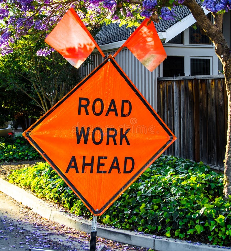 An Orange Sign Warning Road Work Ahead Stock Photo - Image of warning ...