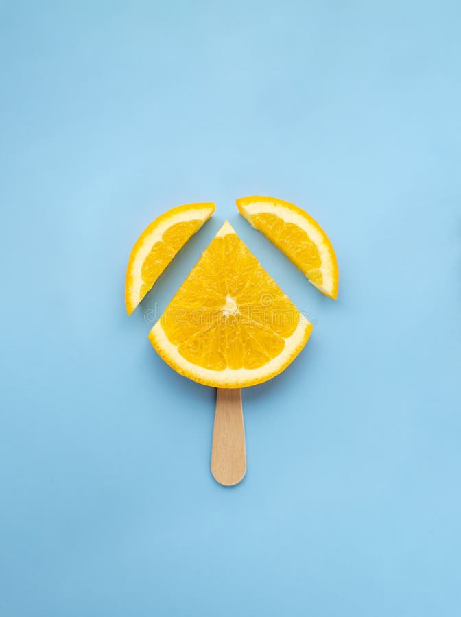 Orange Slice As Ice Cream, Orange on a Stick, Blue Background Stock ...