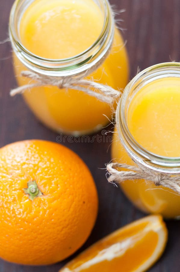 Orange, Slice and Juice in Jars on a Dark Wooden Table, Rustic Style ...