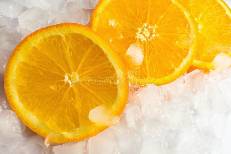 Orange slices in ice stock image. Image of refreshment - 144504173