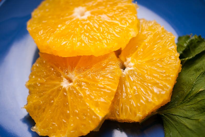 Orange Slices without Peel with Mint Leaves on a Blue Plate Stock Photo ...