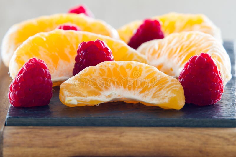 Orange Slices with Raspberries Stock Photo - Image of orange ...