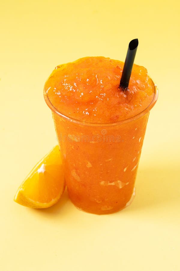Orange Slushie on Yellow Background Stock Photo - Image of drink ...