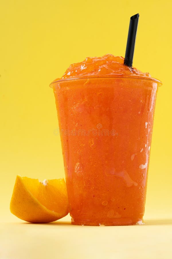 Orange Slushie on Yellow Background Stock Photo - Image of summer, food ...