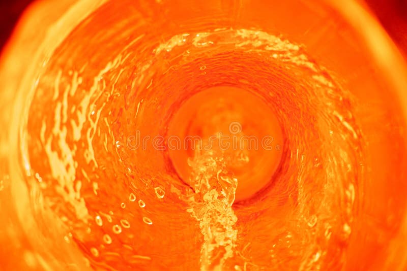 Orange Spinning Fluid Flowing on Top Stock Image - Image of hole, wave ...