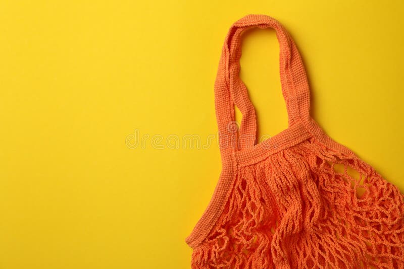 Orange String Bag on Yellow Background, Space for Text Stock Image ...