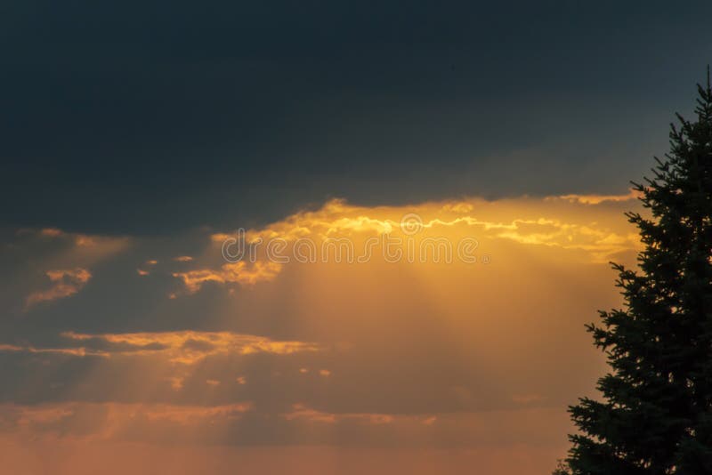 Orange Sun Beams through the Clouds. Dramatic Sky on Sunset Stock Image ...