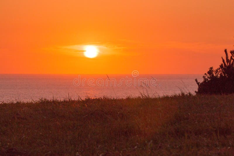 Orange Sun Setting on the Horizon Stock Photo - Image of landscape ...