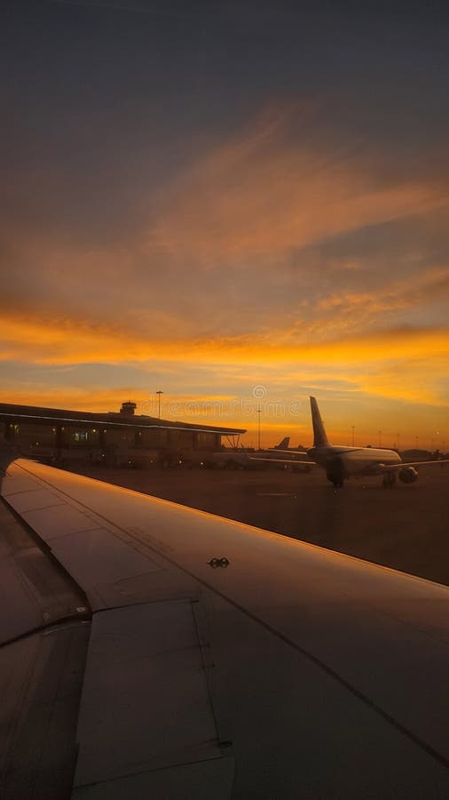Orange Sunset at the Airport with Flight Wings Stock Photo - Image of ...