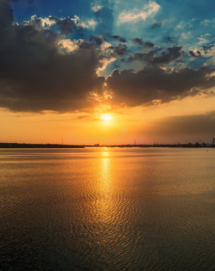 Orange Sunset in Dramatic Clouds Over Water Stock Image - Image of ...