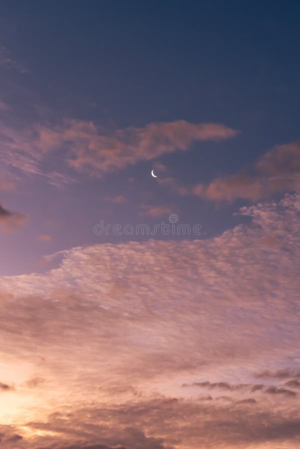 An Orange Sunset with a Lone Moon in the Sky Stock Photo - Image of ...