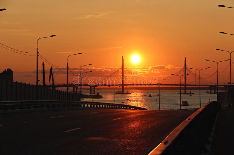 Orange Sunset Over the Highway with a Bridge Over the River and Stock ...