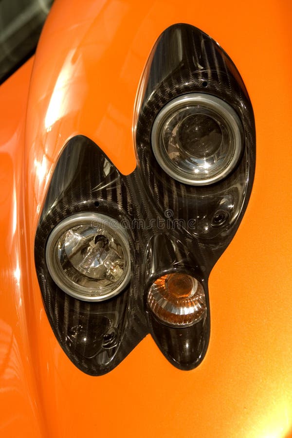 Orange supercar headlights stock image. Image of super - 5595617