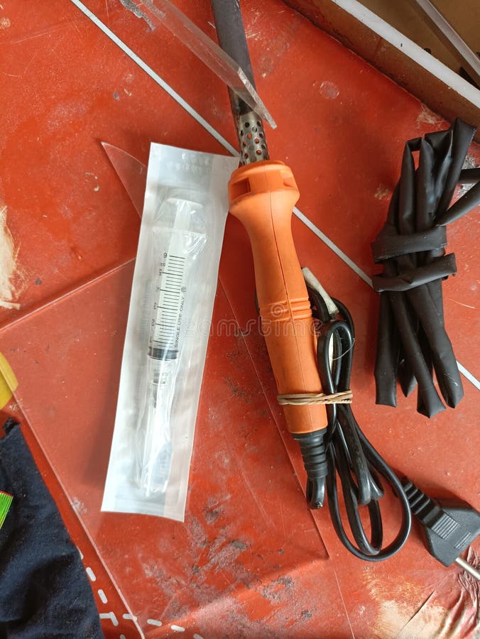 Orange Table with Solder Injection and Some Wires Stock Photo - Image ...