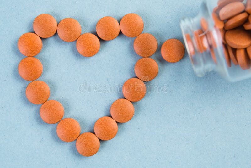 The Orange Tablets are Arranged in the Shape of a Heart. Vitamins for ...