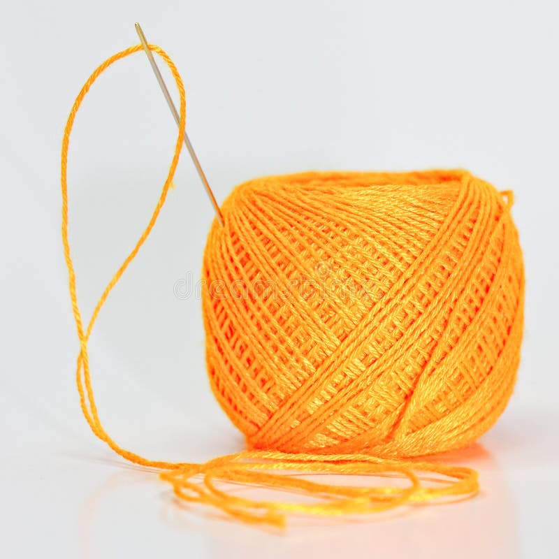 Orange thread and needle stock photo. Image of cotton - 50124034
