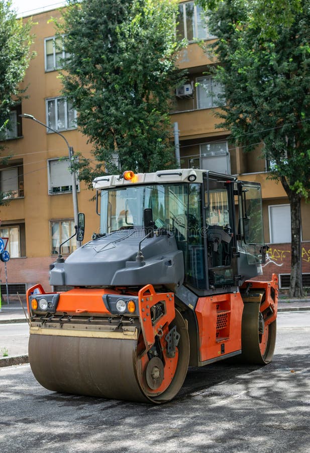 Orange Tractor with Cylinder for Asphalt Paving on Road Stock Image ...