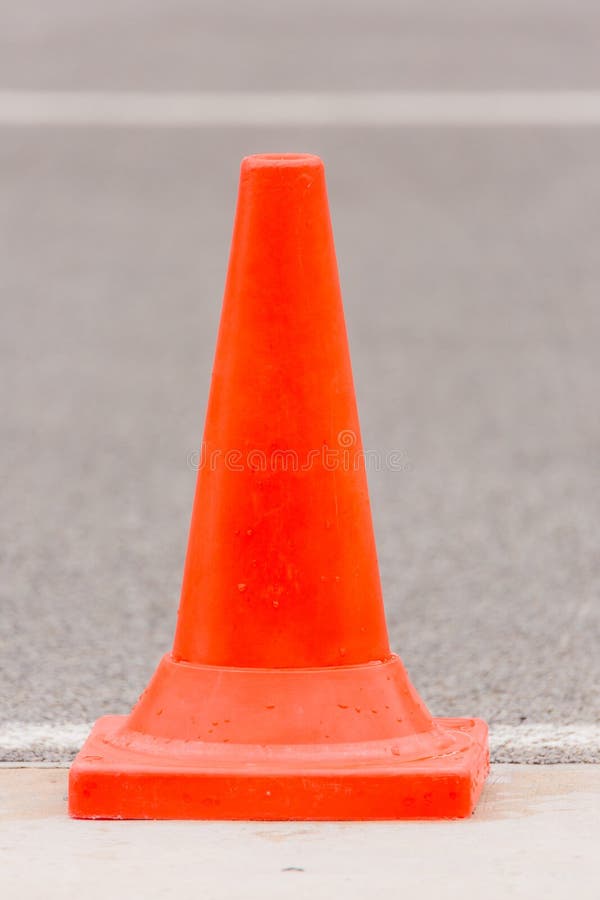 An Orange Traffic Cone is Placed on the Edge of the Racetrack Stock ...