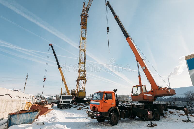 Orange Truck Crane at Work on a Construction Site in Winter Stock Image ...