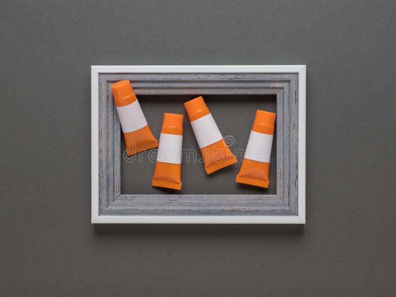 Orange Tubes in a Gray Frame on a Gray Background Stock Photo - Image ...