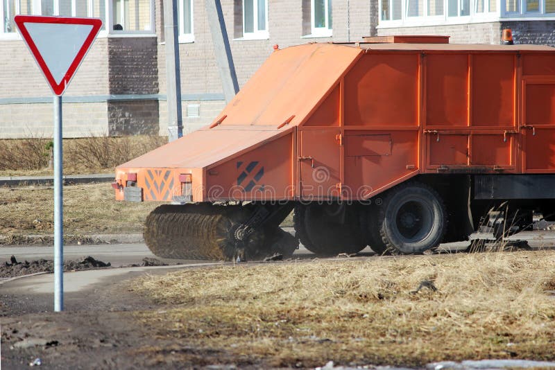 Orange Urban Sweeper Cleans Road from Dirt with a Round Brush in the ...