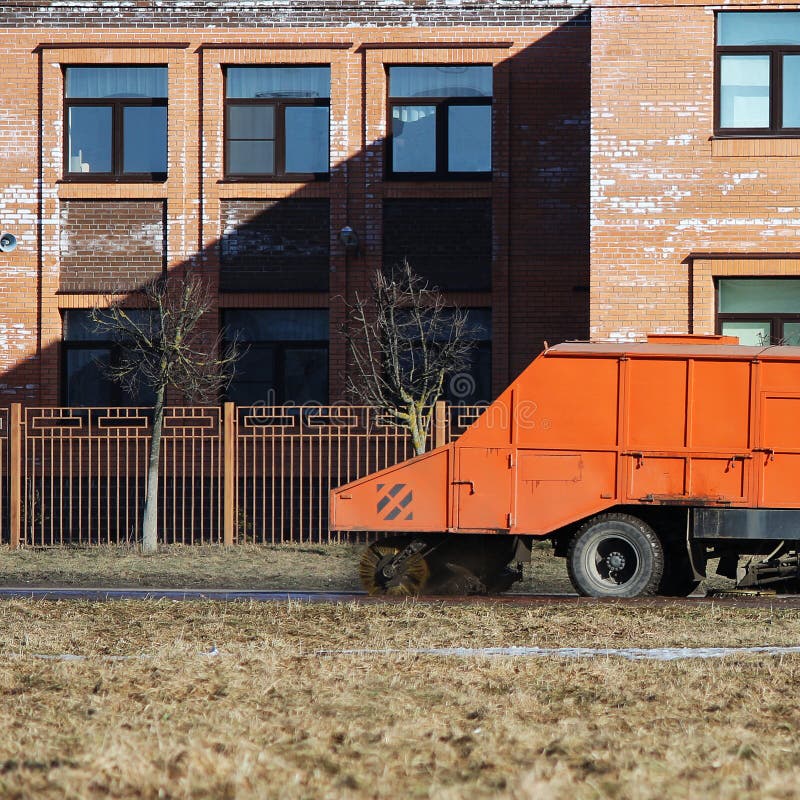 Orange Urban Sweeper Cleans Road from Dirt with a Round Brush in the ...