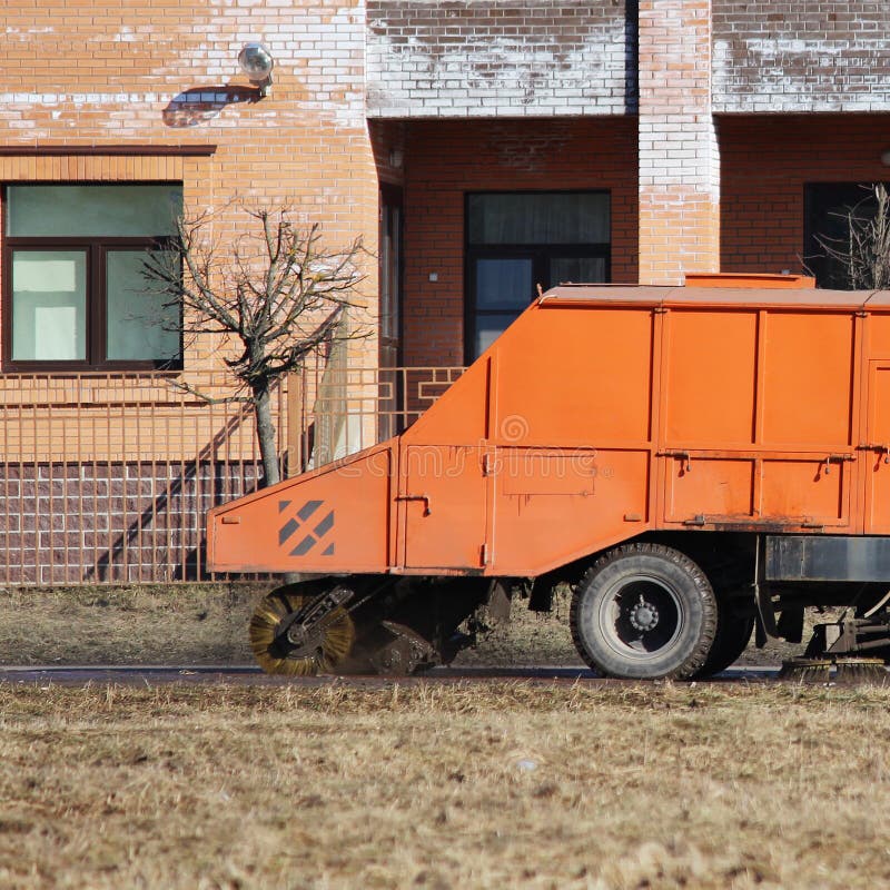 Orange Urban Sweeper Cleans Road from Dirt with a Round Brush in the ...