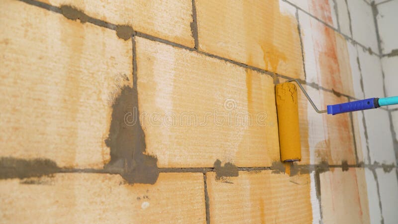 Orange Wall Primer. Priming a Concrete Block Wall with an Orange Primer ...