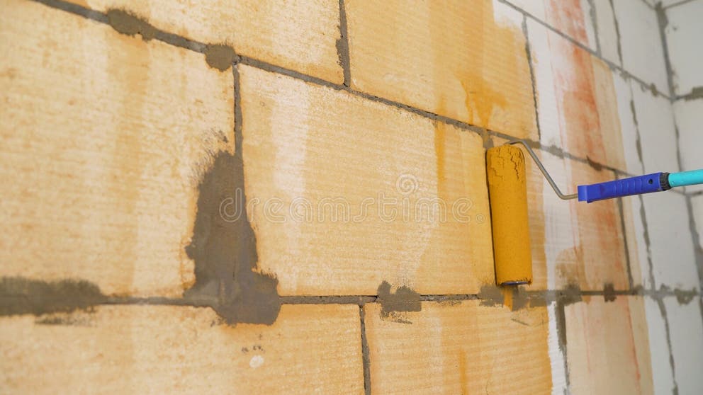 Orange Wall Primer. Priming a Concrete Block Wall with an Orange Primer ...