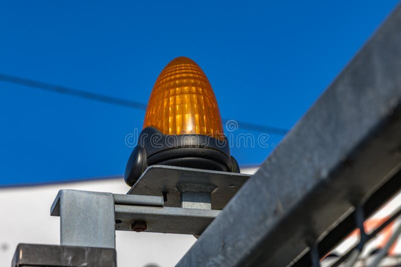 Orange Warning Light Mounted on a Metal Fence, High Metal Fence on the ...
