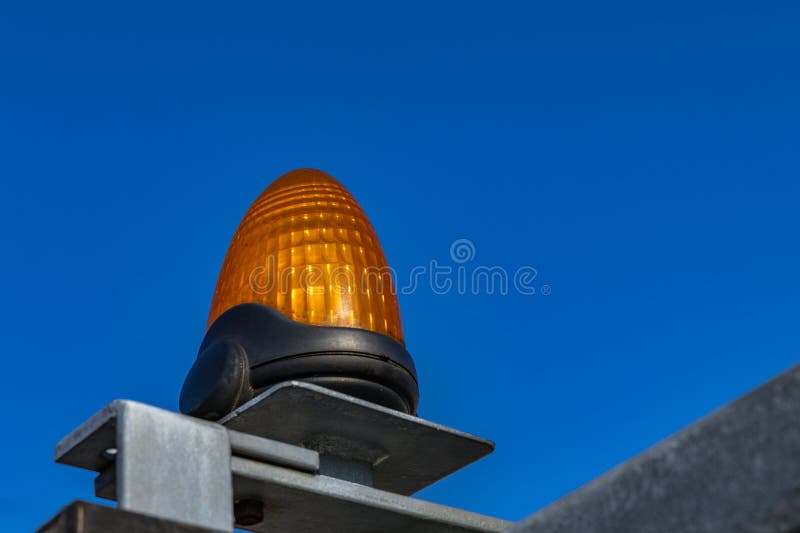 Orange Warning Light Mounted on a Metal Fence, High Metal Fence on the ...