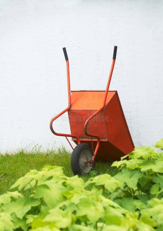 Orange Wheelbarrow on Grass Stock Image - Image of garden, orange: 87316029