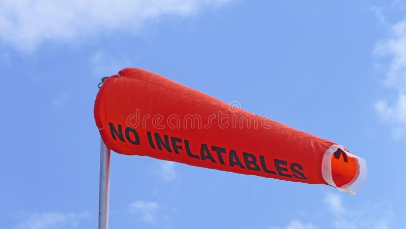 Orange Windsock and Beach Warning Flags Indicating Sea Hazard on Sandy ...