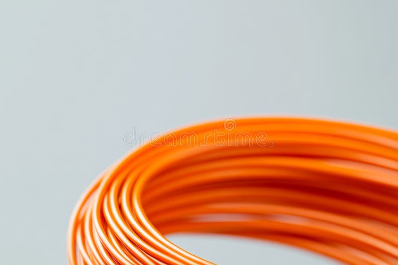 Orange Wire Coil Twisted Neatly for Crafting Projects or Electrical Use ...