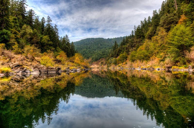 Orange and Yellow Fall Colors Reflect in the Rogue River on a Calm ...