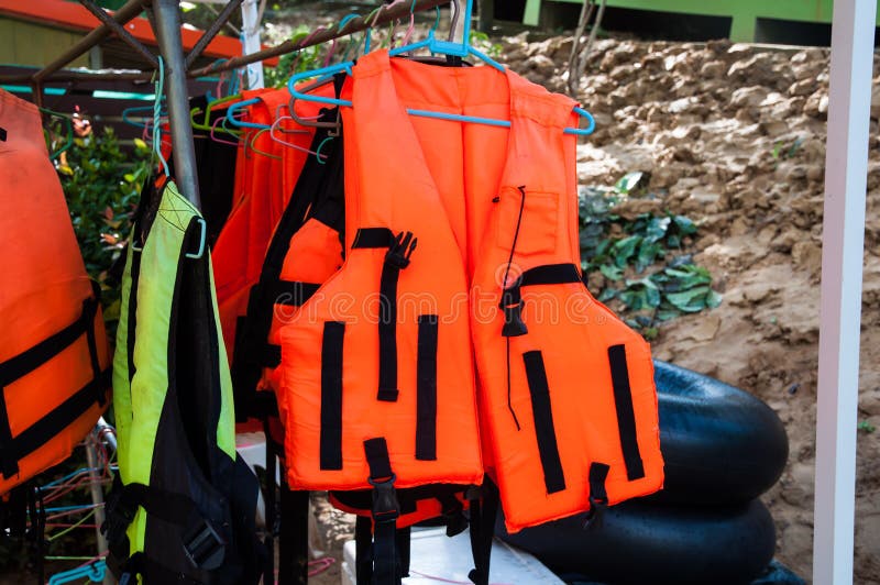 Orange and Yellow Life Jackets on Hanger. Stock Image - Image of swim ...
