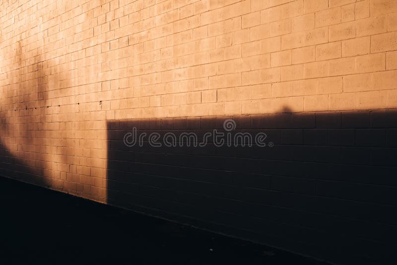 Orange Yellow Shadow on the Wall Texture and Asphalt Stock Image ...