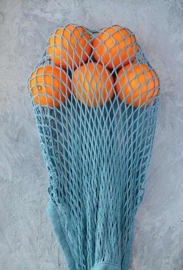 Oranges in Blue String Bag on Gray Background. Orange, Grapefruit ...