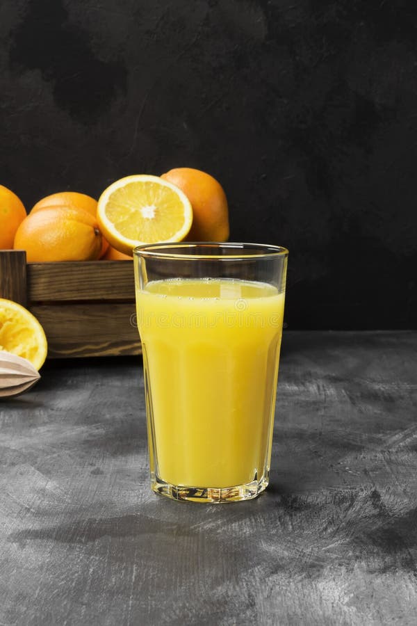 Oranges and Fresh Orange Juice on a Black Background Stock Photo ...