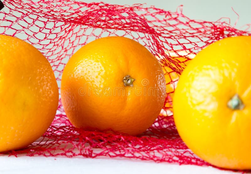 Oranges on the net stock photo. Image of healthy, wood - 34603454
