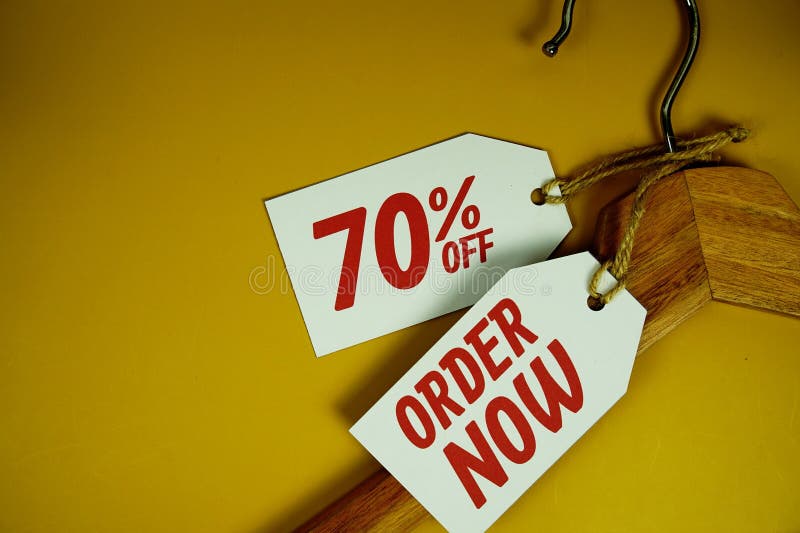 Order Now and Sale 70 on Price Tag with Wooden Clothes Hanger on Yellow ...